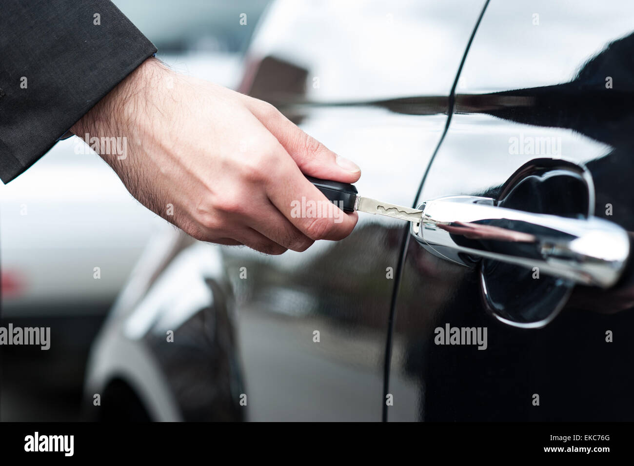 Man inserting car key into the door lock Stock Photo - Alamy