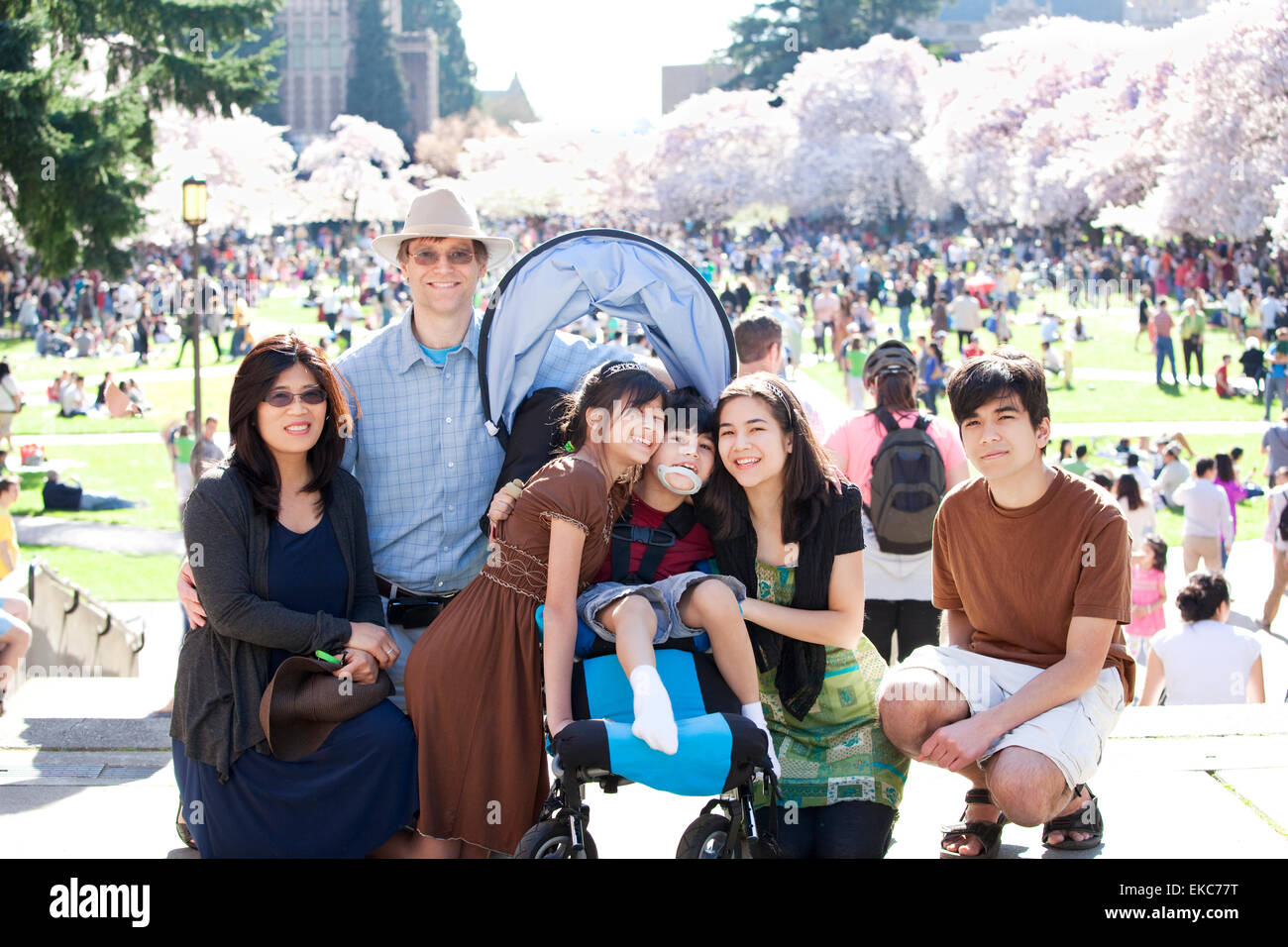 Large multiracial family in crowd with disabled child in wheelch Stock ...