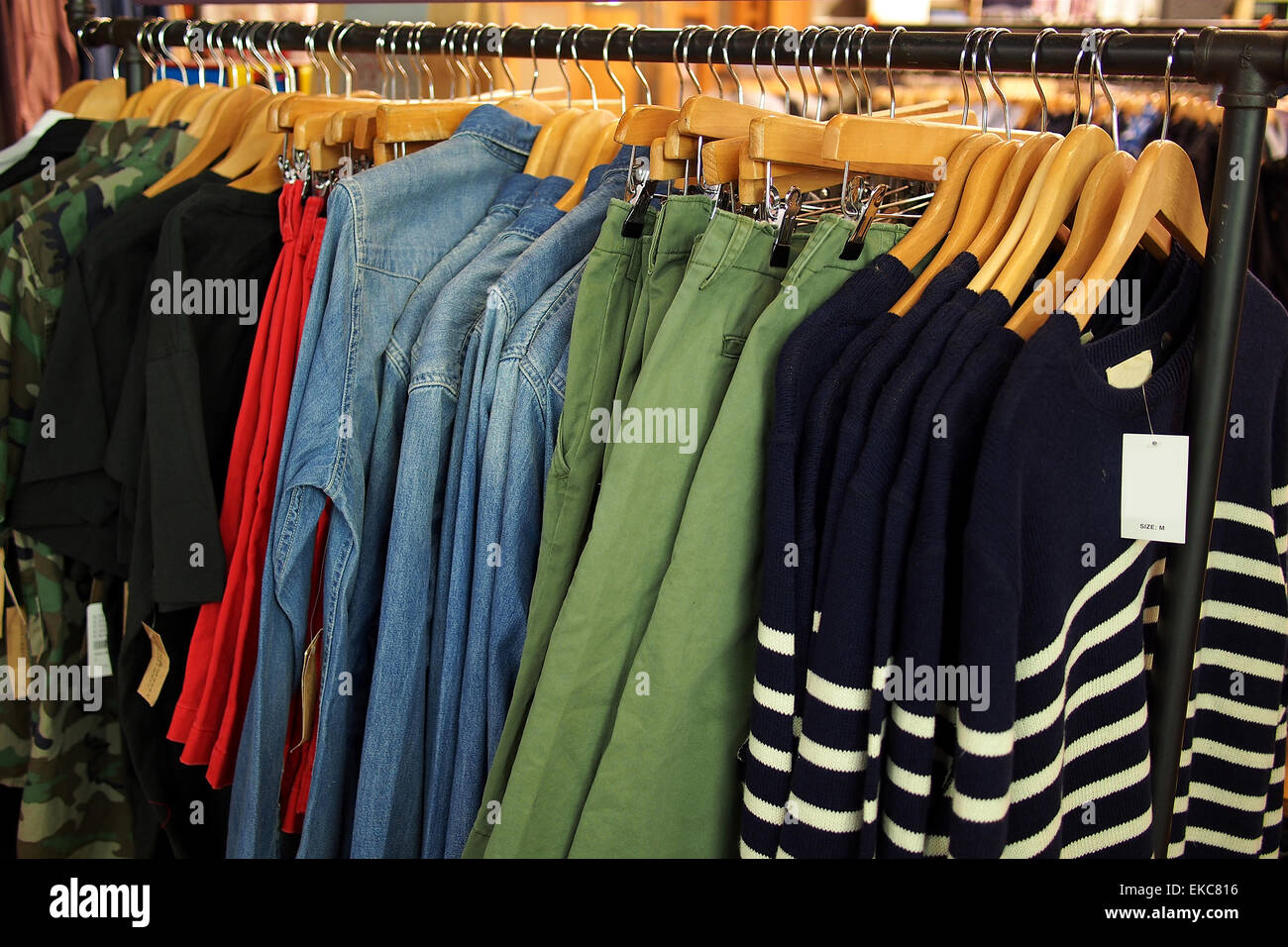 Fashion clothing on hangers in a shop Stock Photo - Alamy