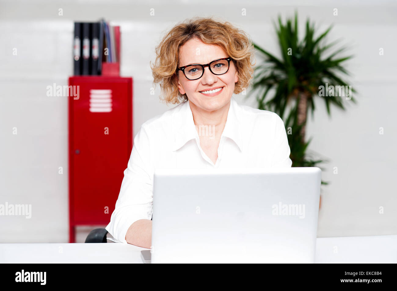 Pretty business woman working in the office Stock Photo - Alamy