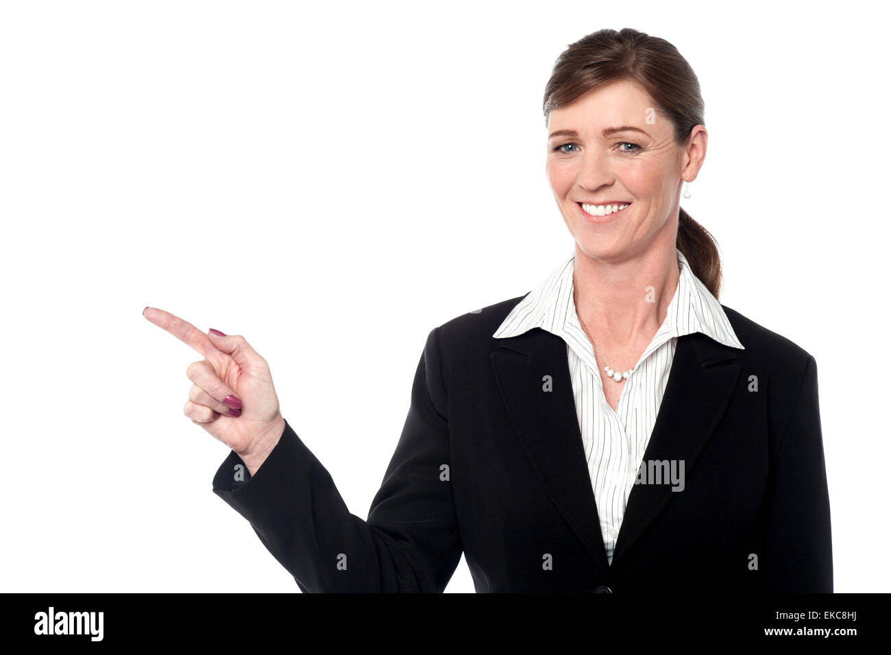 Smiling professional lady pointing away Stock Photo - Alamy