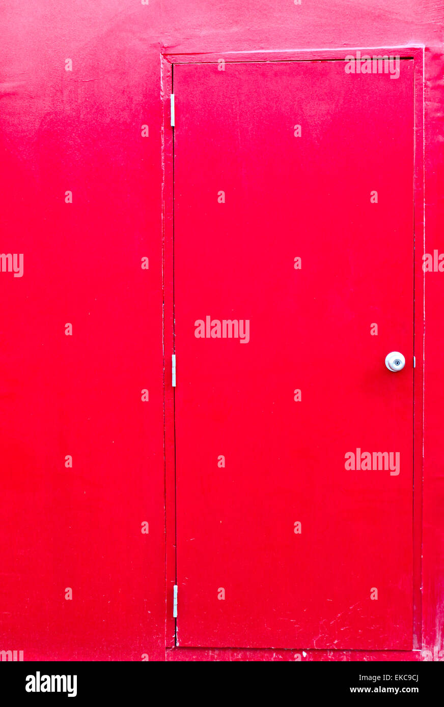 Closed red door with red wall Stock Photo - Alamy