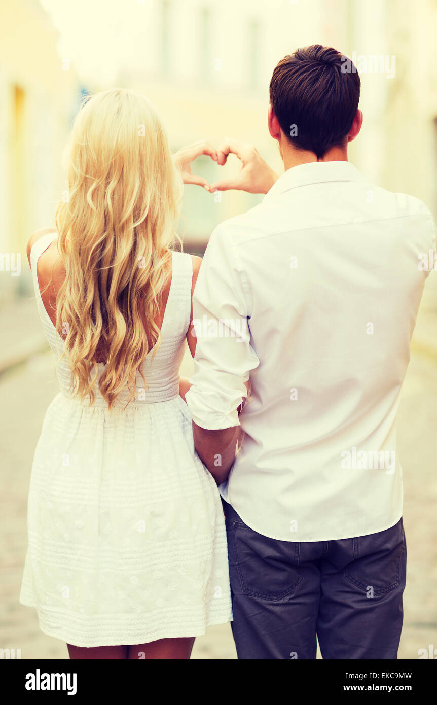 romantic couple in the city making heart shape Stock Photo - Alamy