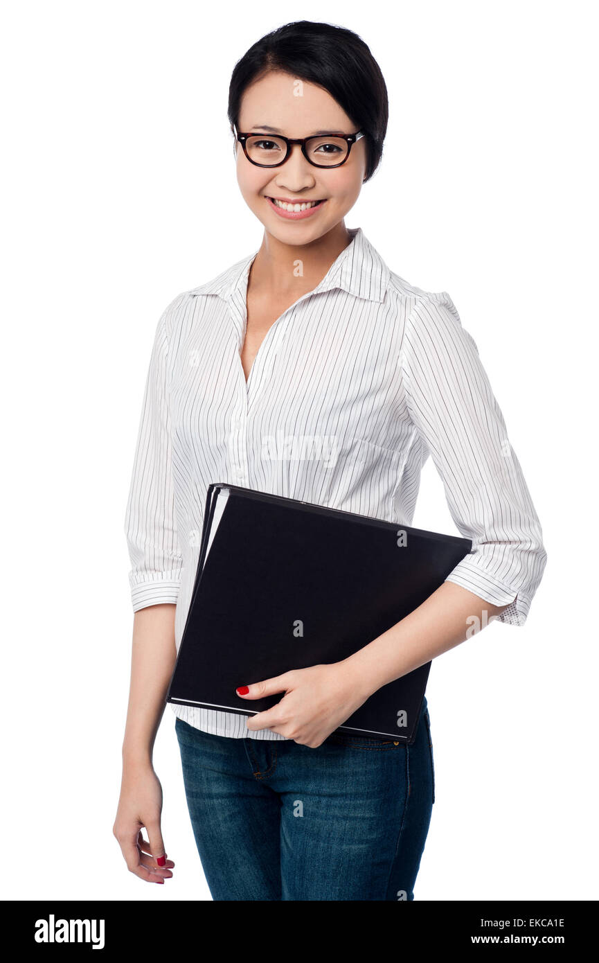 Smiling female executive holding business files Stock Photo - Alamy