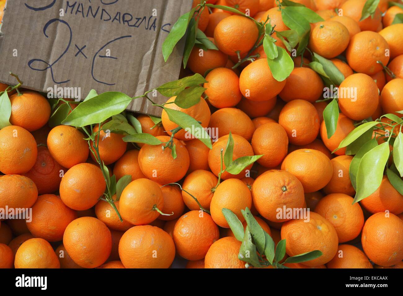 Valencia oranges stacked on market Stock Photo - Alamy