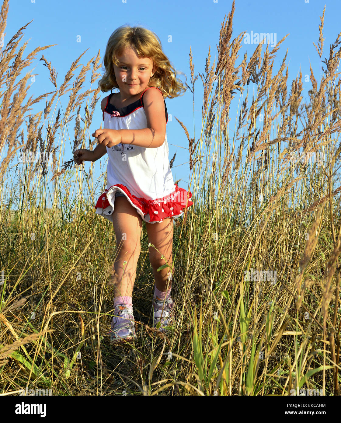 Running Happy little girl Stock Photo - Alamy