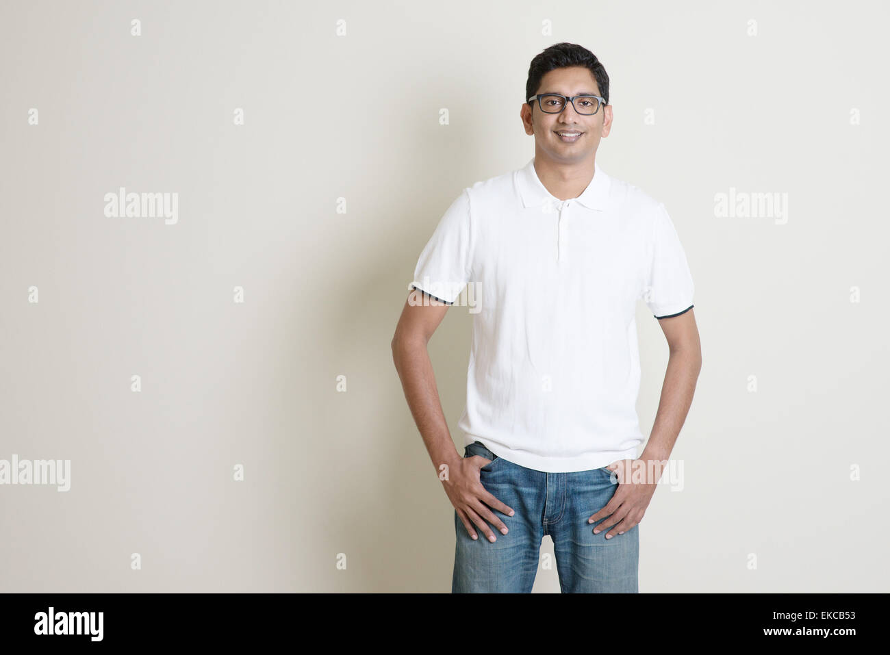 Front view portrait Indian guy standing on plain background with shadow ...