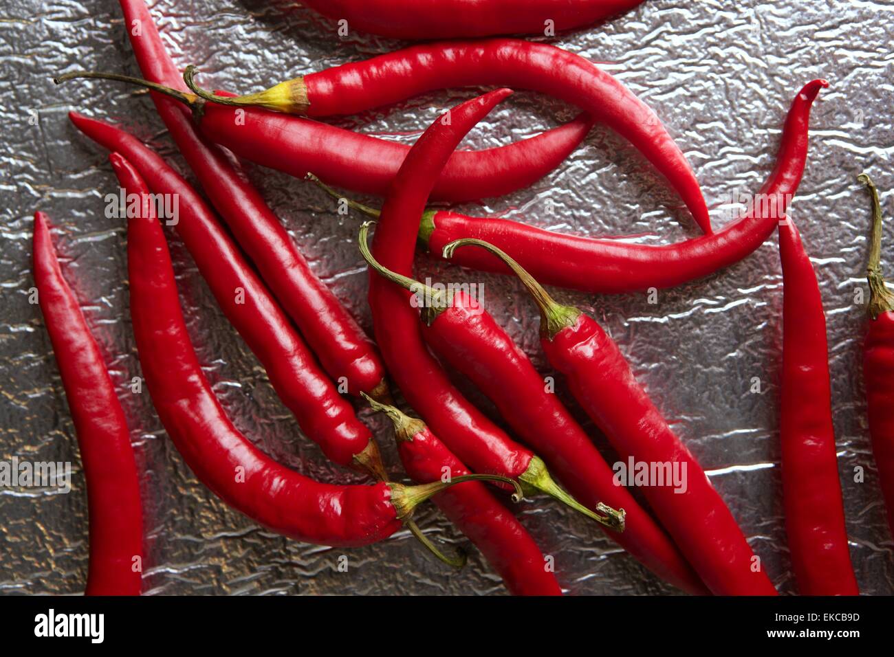 Chili hot peppers in red pattern over silver Stock Photo - Alamy