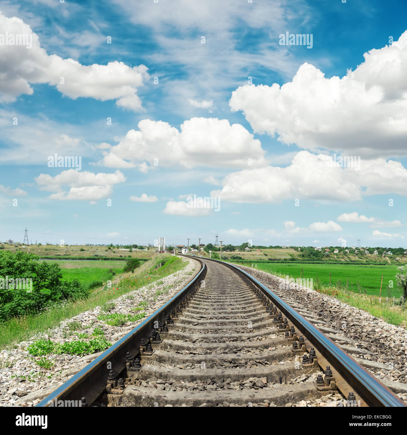 railroad to horizon in green landscape and cloudy sky Stock Photo - Alamy