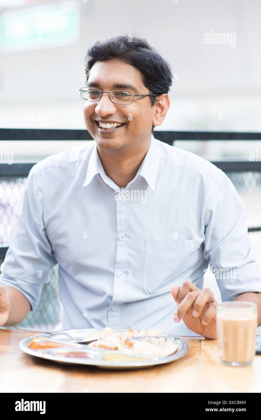 Asian Indian businessman eating food at cafeteria Stock Photo - Alamy