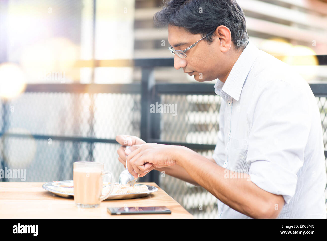 Asian Indian businessman eating roti at cafeteria Stock Photo - Alamy