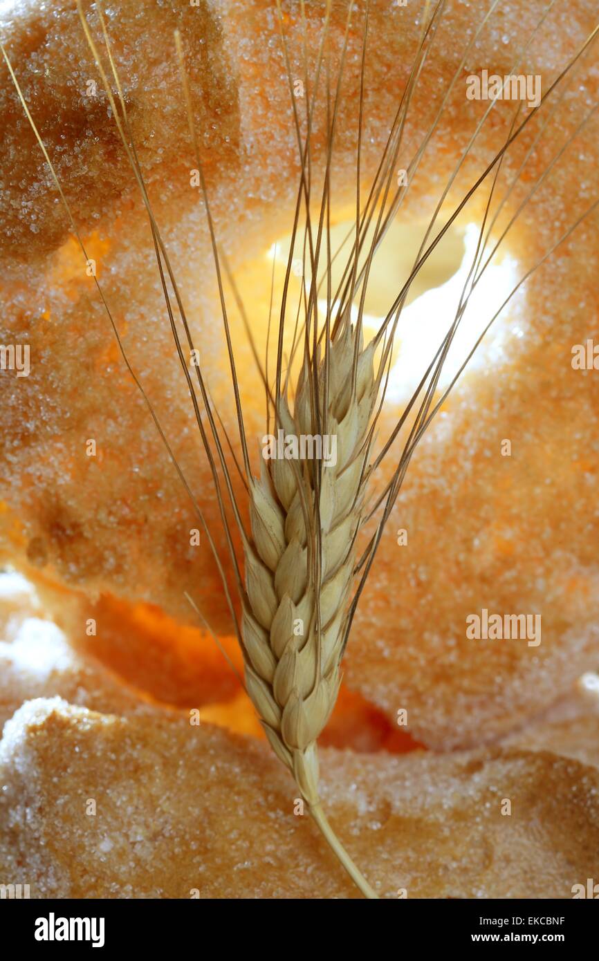 Delicious roll bakery sugar and wheat spikes Stock Photo - Alamy