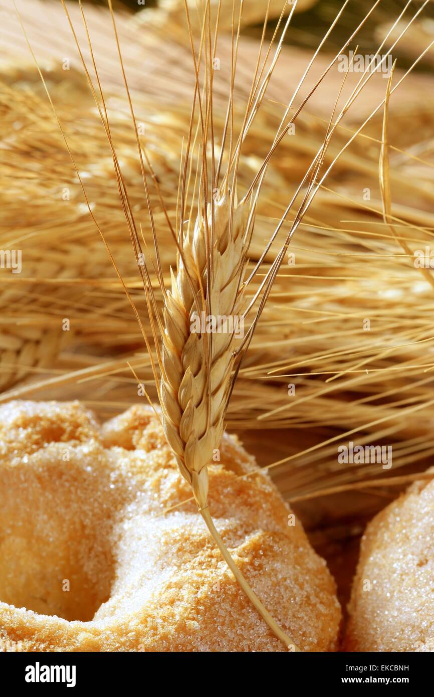 Delicious roll bakery sugar and wheat spikes Stock Photo - Alamy