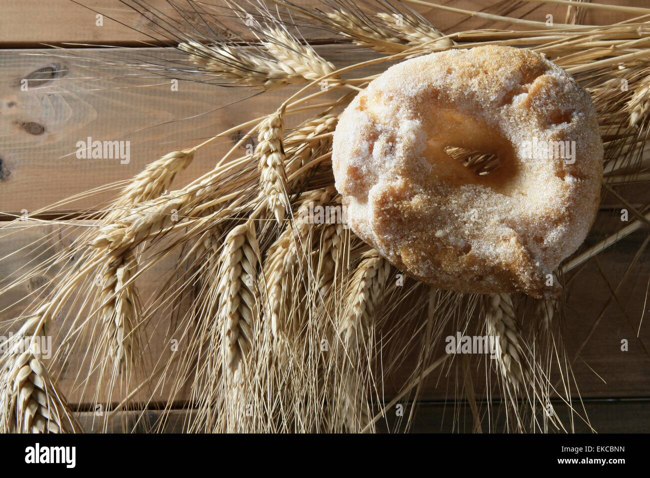 Delicious roll bakery sugar and wheat spikes Stock Photo - Alamy