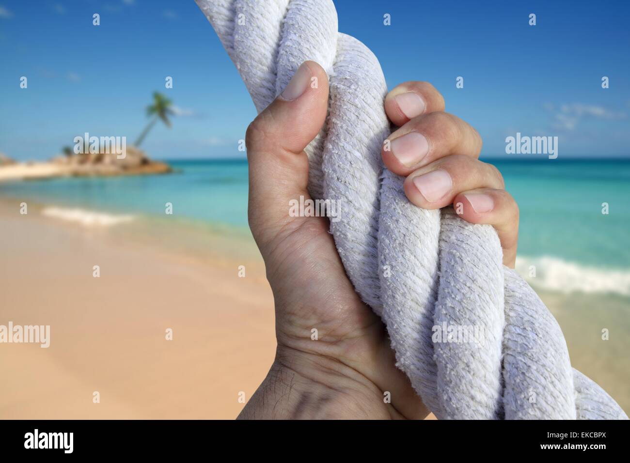 man hand grab grip adventure paradise beach rope Stock Photo - Alamy