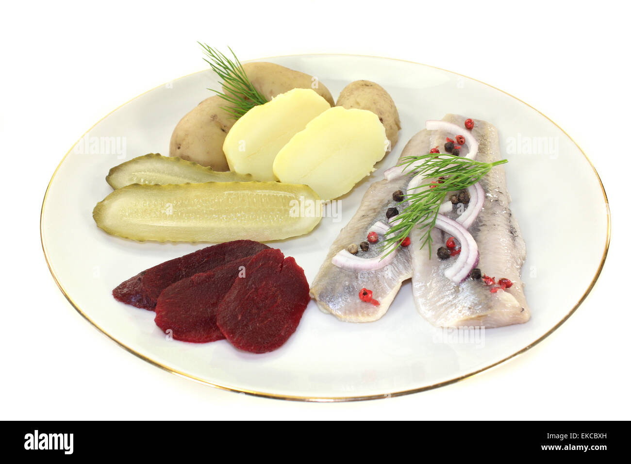 a plate of pickled herring fillet, boiled potatoes, beetroot and ...