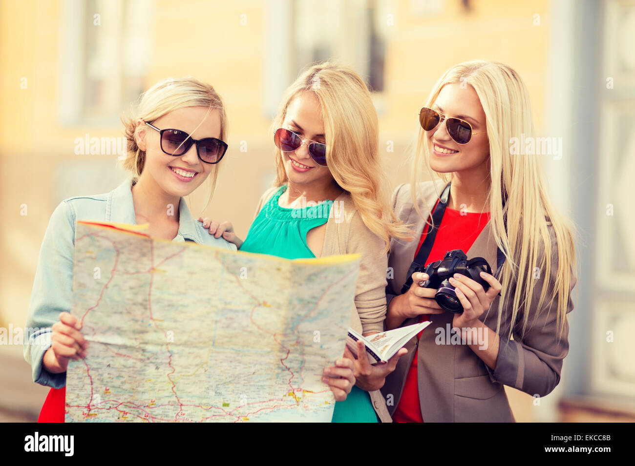 beautiful women with tourist map in the city Stock Photo - Alamy