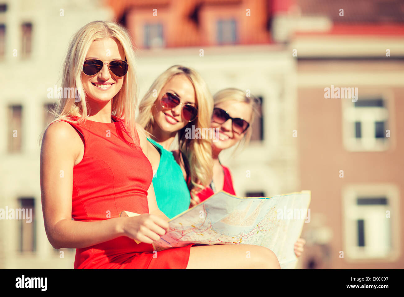 beautiful three women with tourist map in the city Stock Photo - Alamy