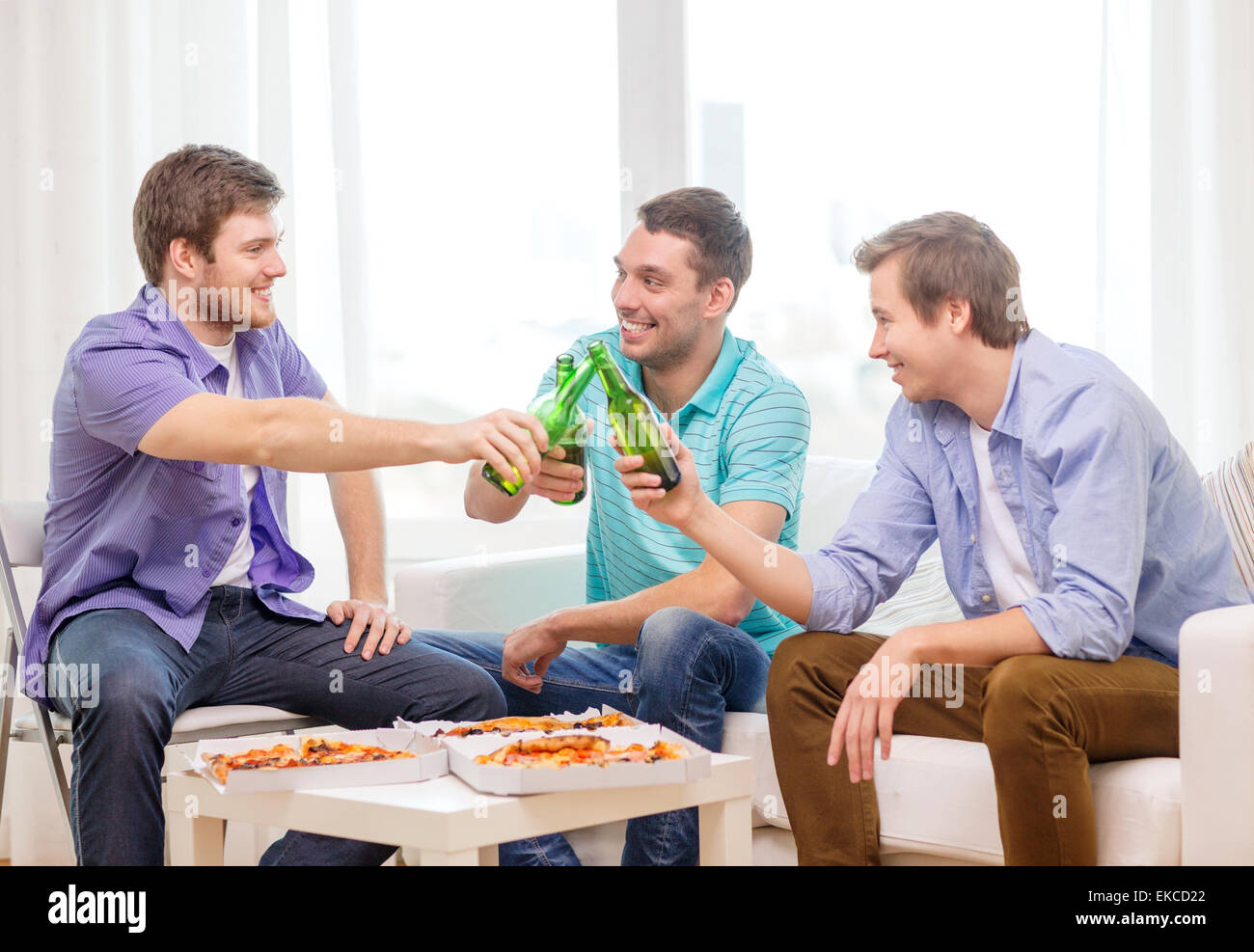 smiling friends with beer and pizza hanging out Stock Photo - Alamy