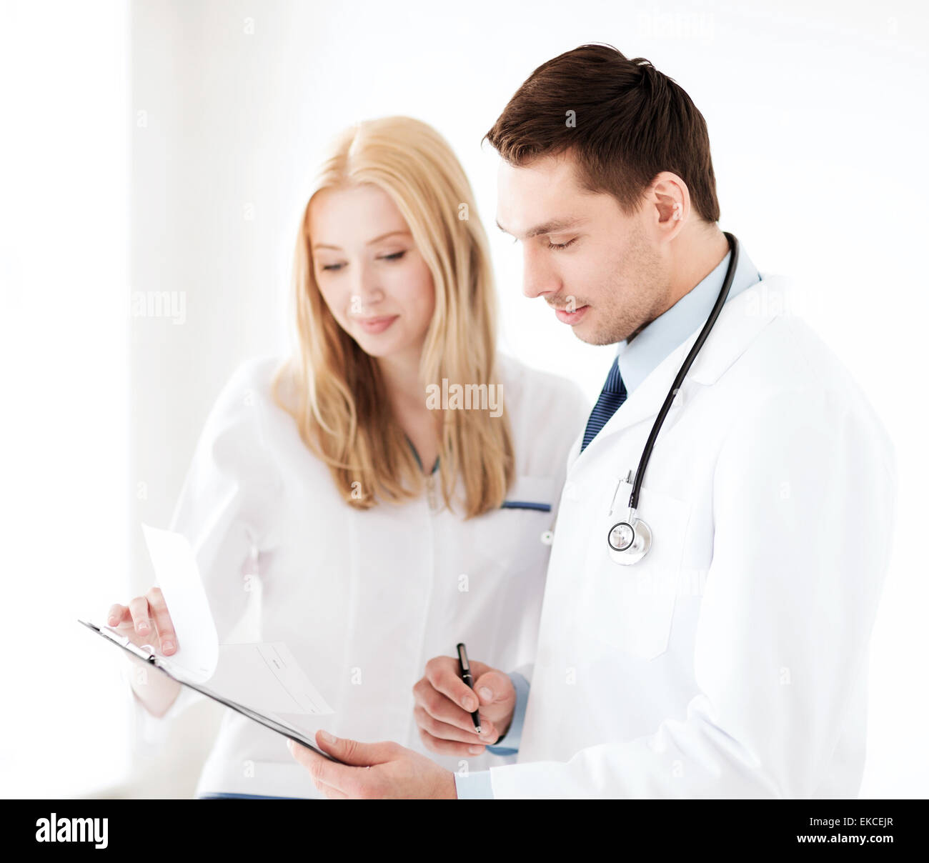 two doctors writing prescription Stock Photo - Alamy