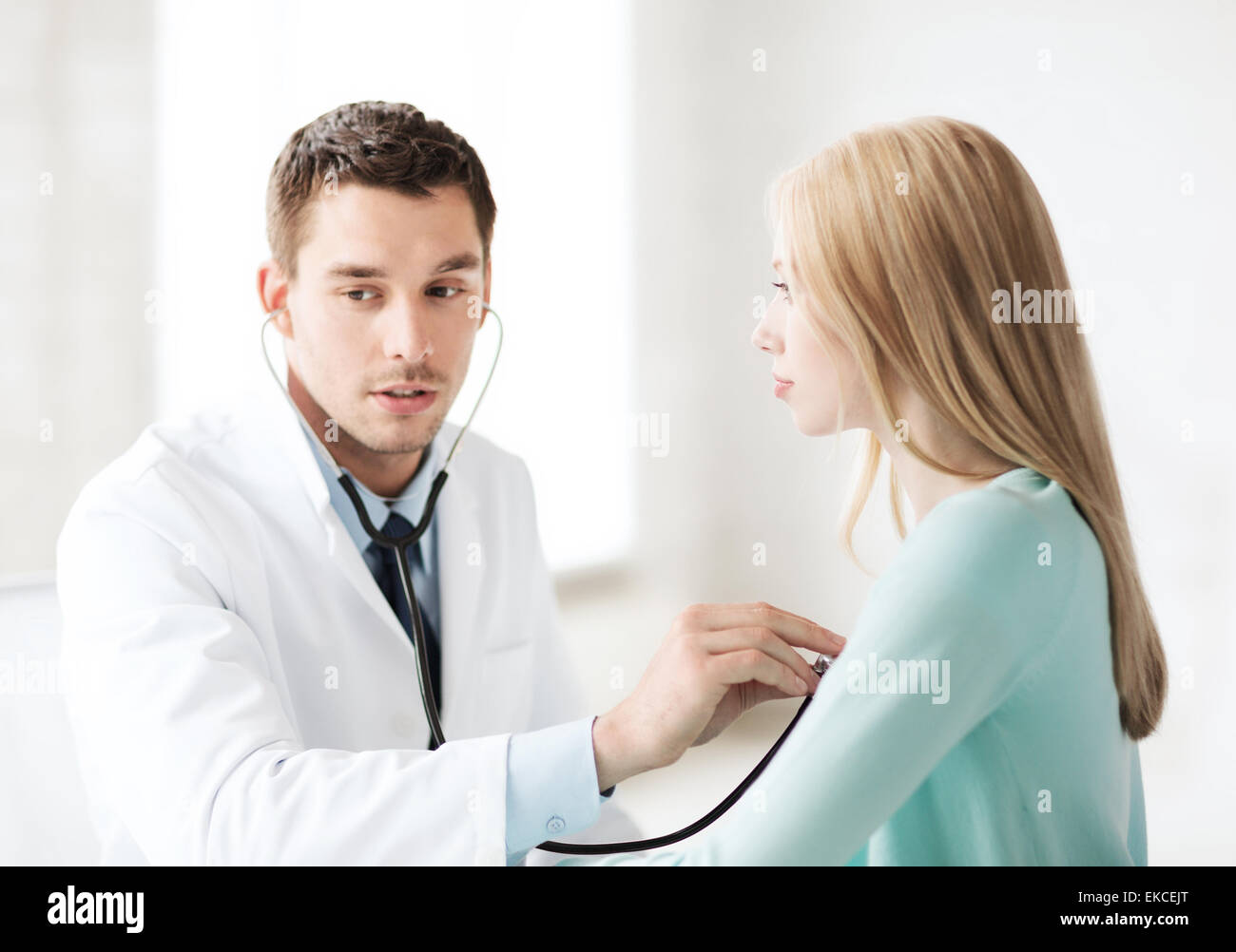 doctor with stethoscope listening to the patient Stock Photo - Alamy