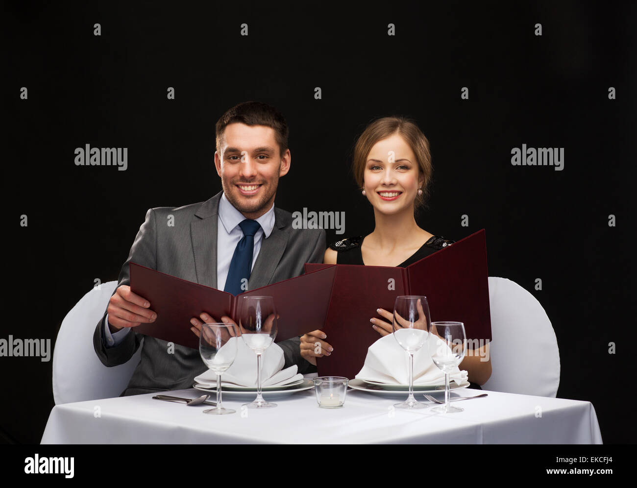 smiling couple with menus at restaurant Stock Photo - Alamy