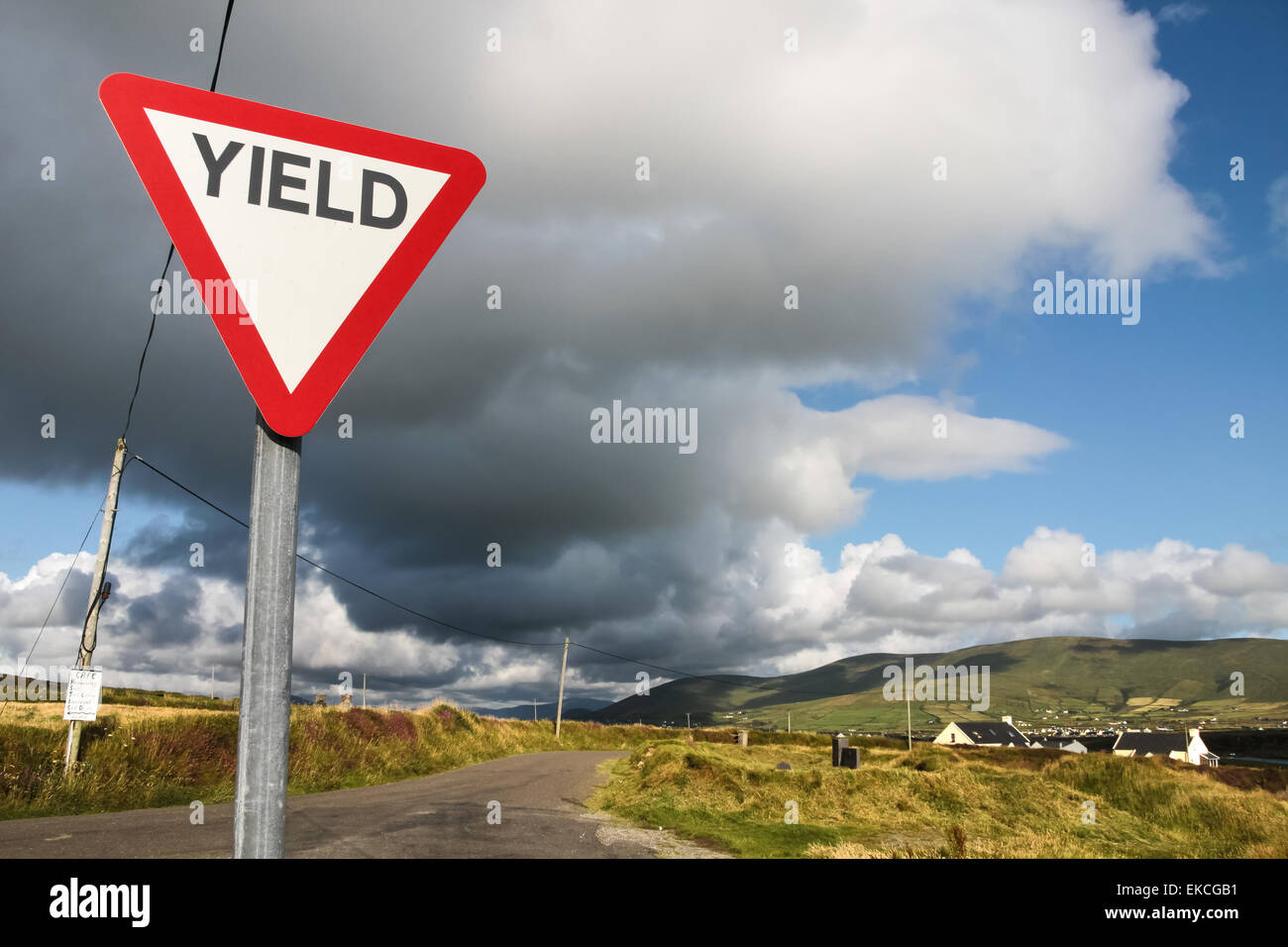 Give way sign with dark clouds in Ireland Stock Photo - Alamy