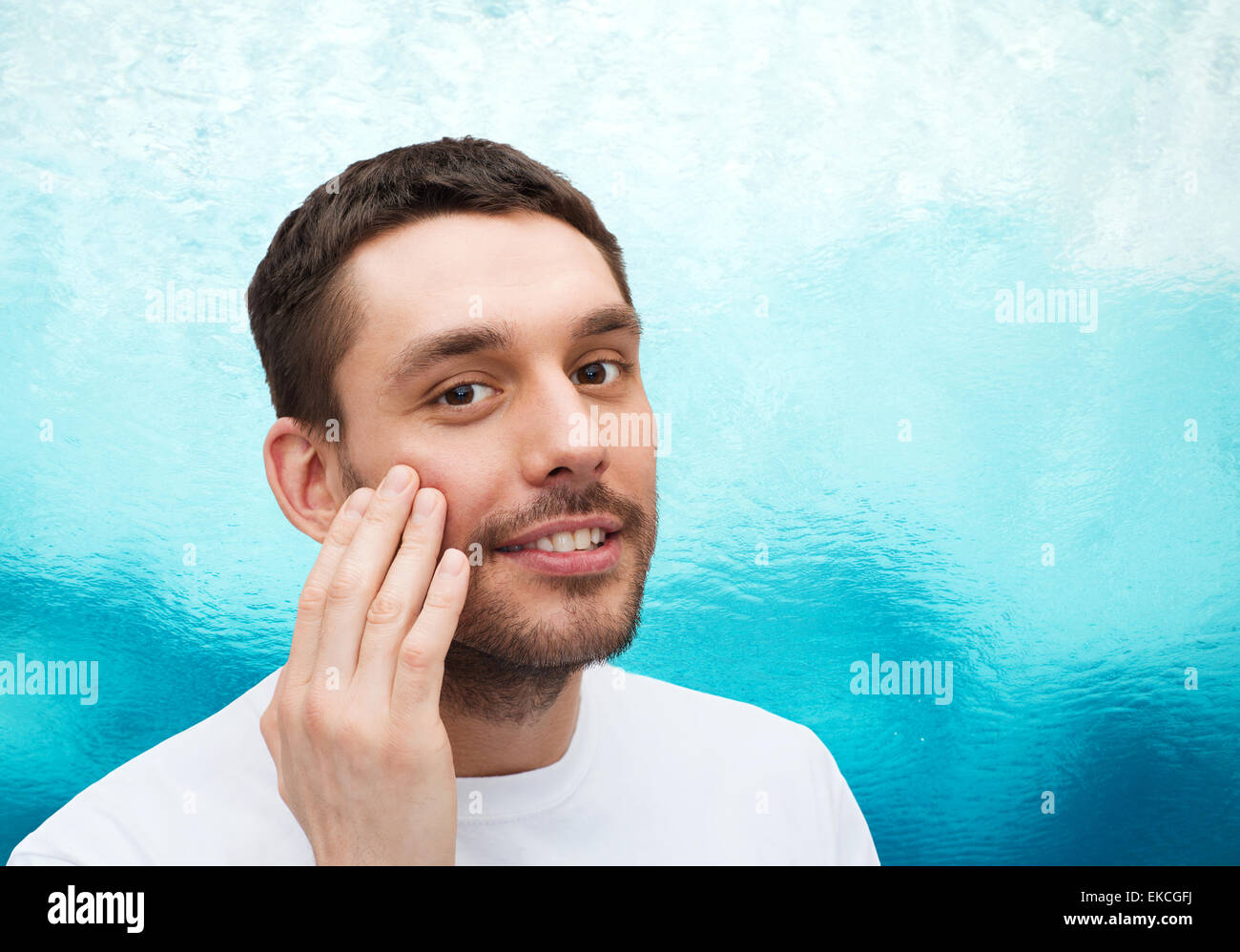 beautiful smiling man touching his face Stock Photo - Alamy