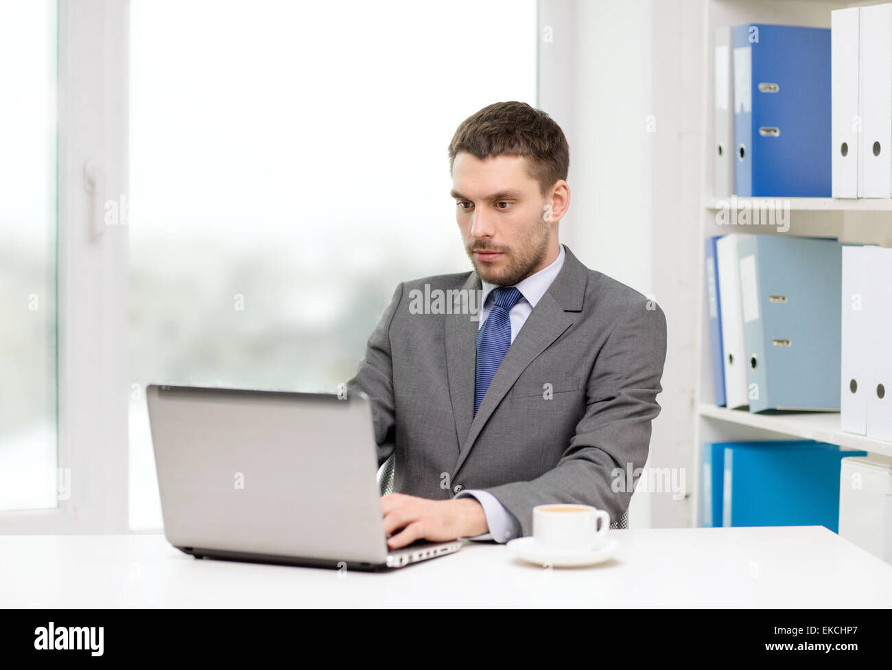 busy businessman with laptop and coffee Stock Photo - Alamy