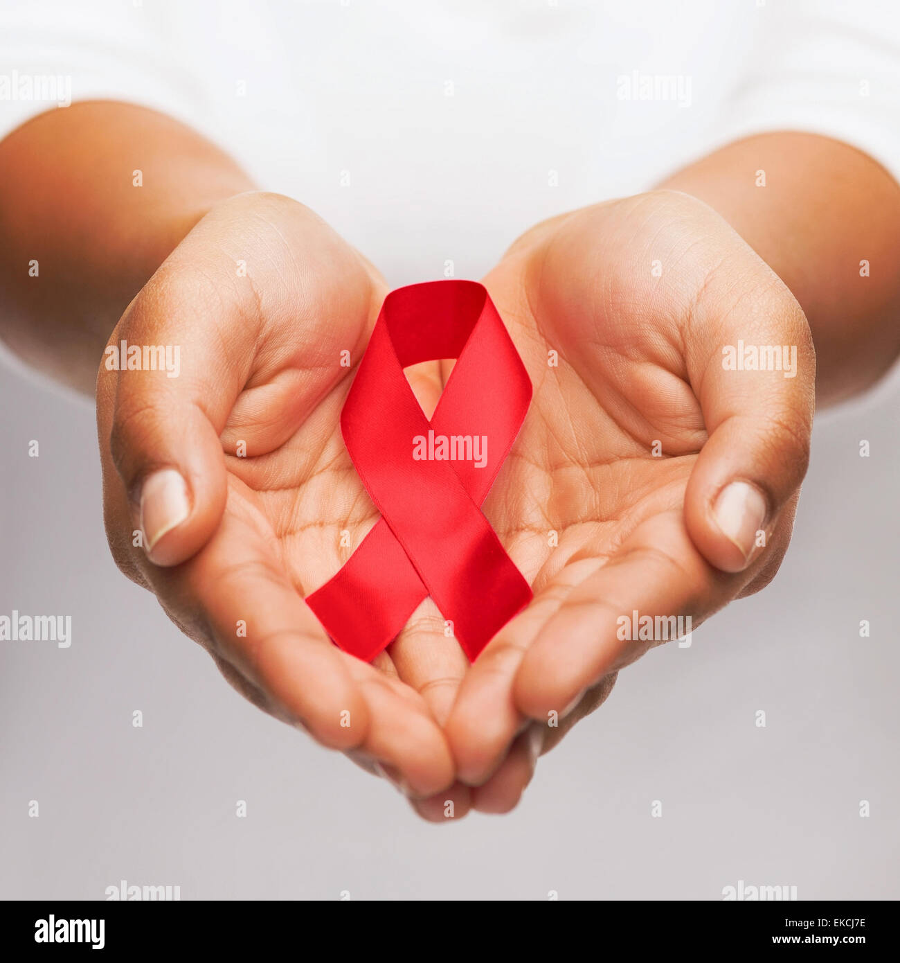 hands holding red AIDS awareness ribbon Stock Photo - Alamy