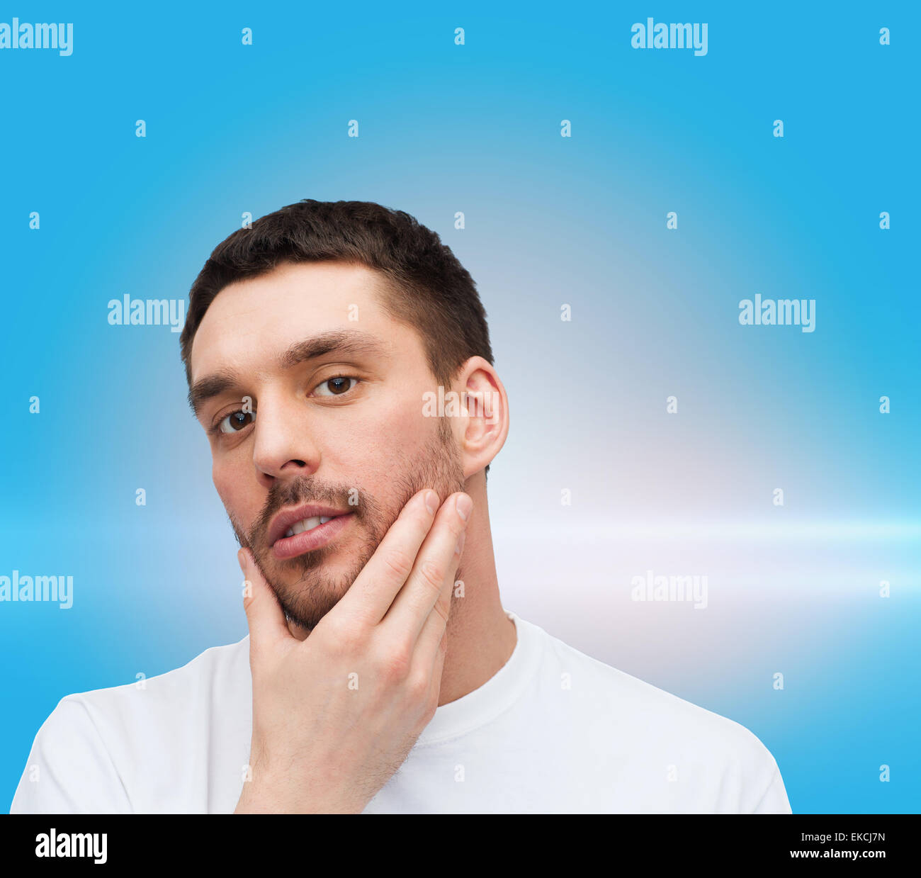 beautiful calm man touching his face Stock Photo - Alamy