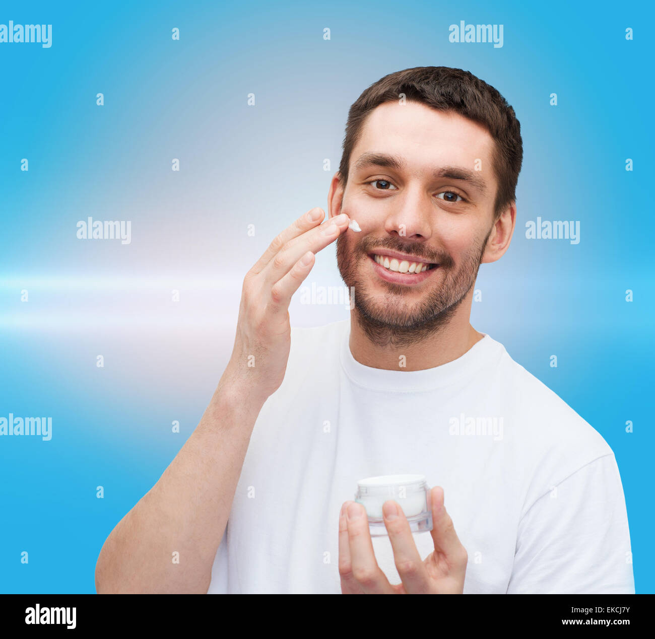 Beautiful smiling man applyin cream hi-res stock photography and images ...
