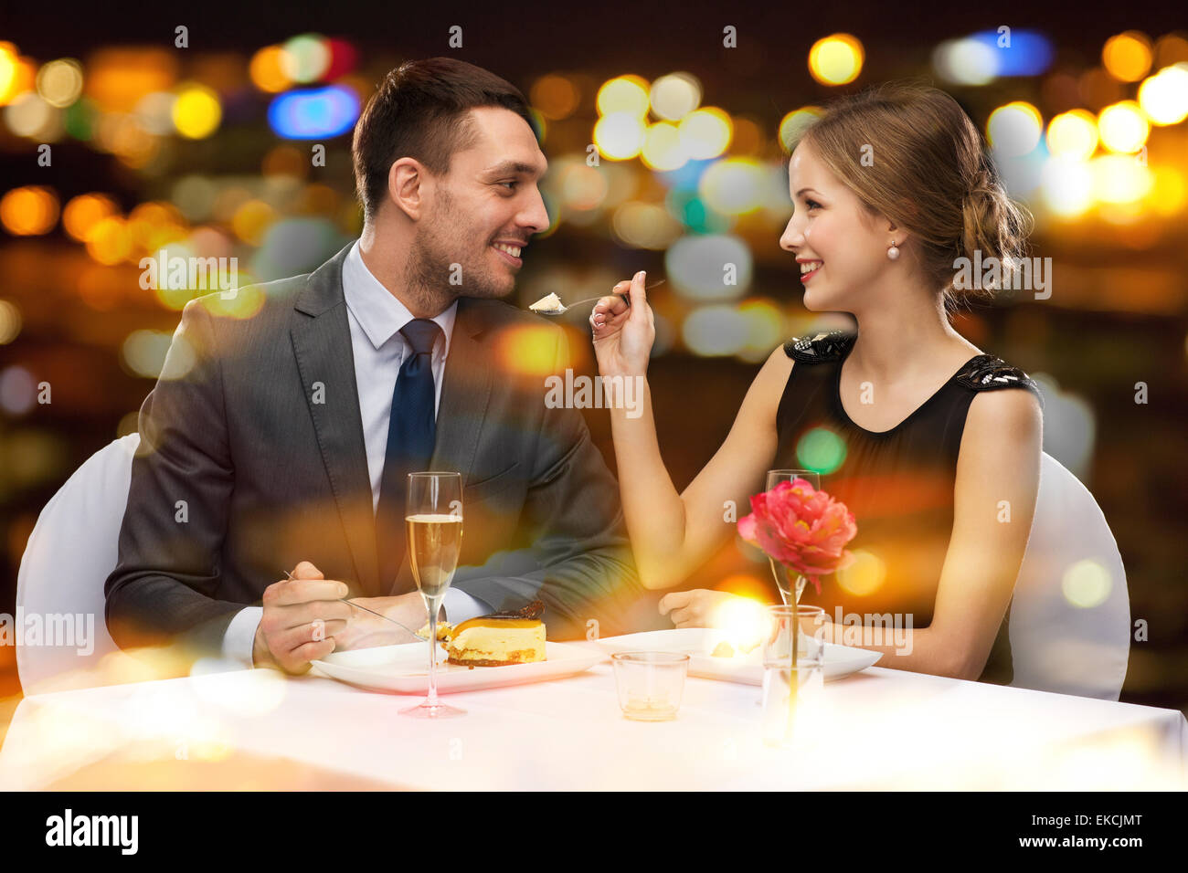 smiling couple eating dessert at restaurant Stock Photo - Alamy