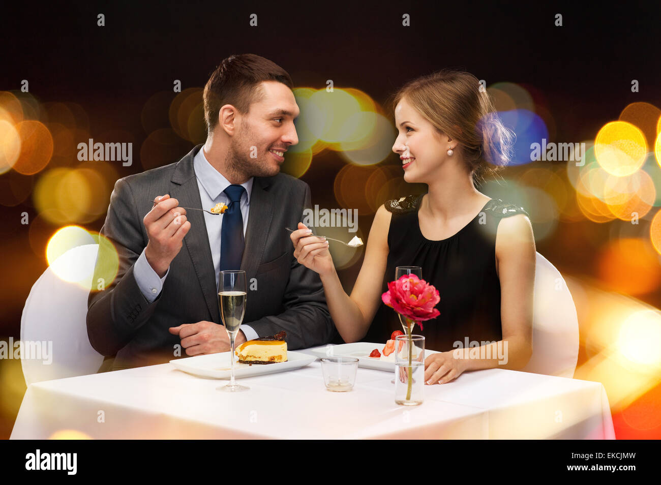 smiling couple eating dessert at restaurant Stock Photo - Alamy