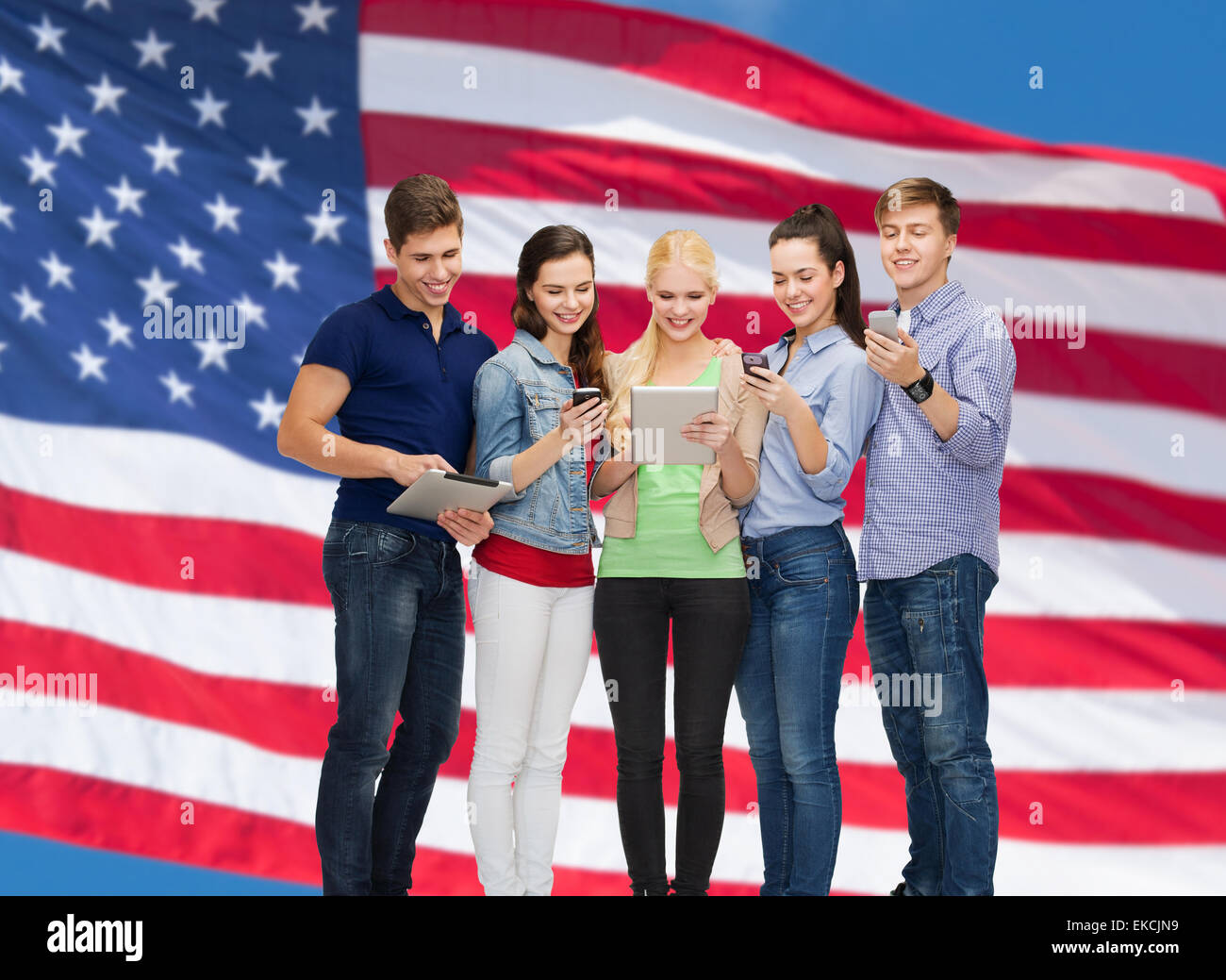 smiling students using smartphones and tablet pc Stock Photo - Alamy