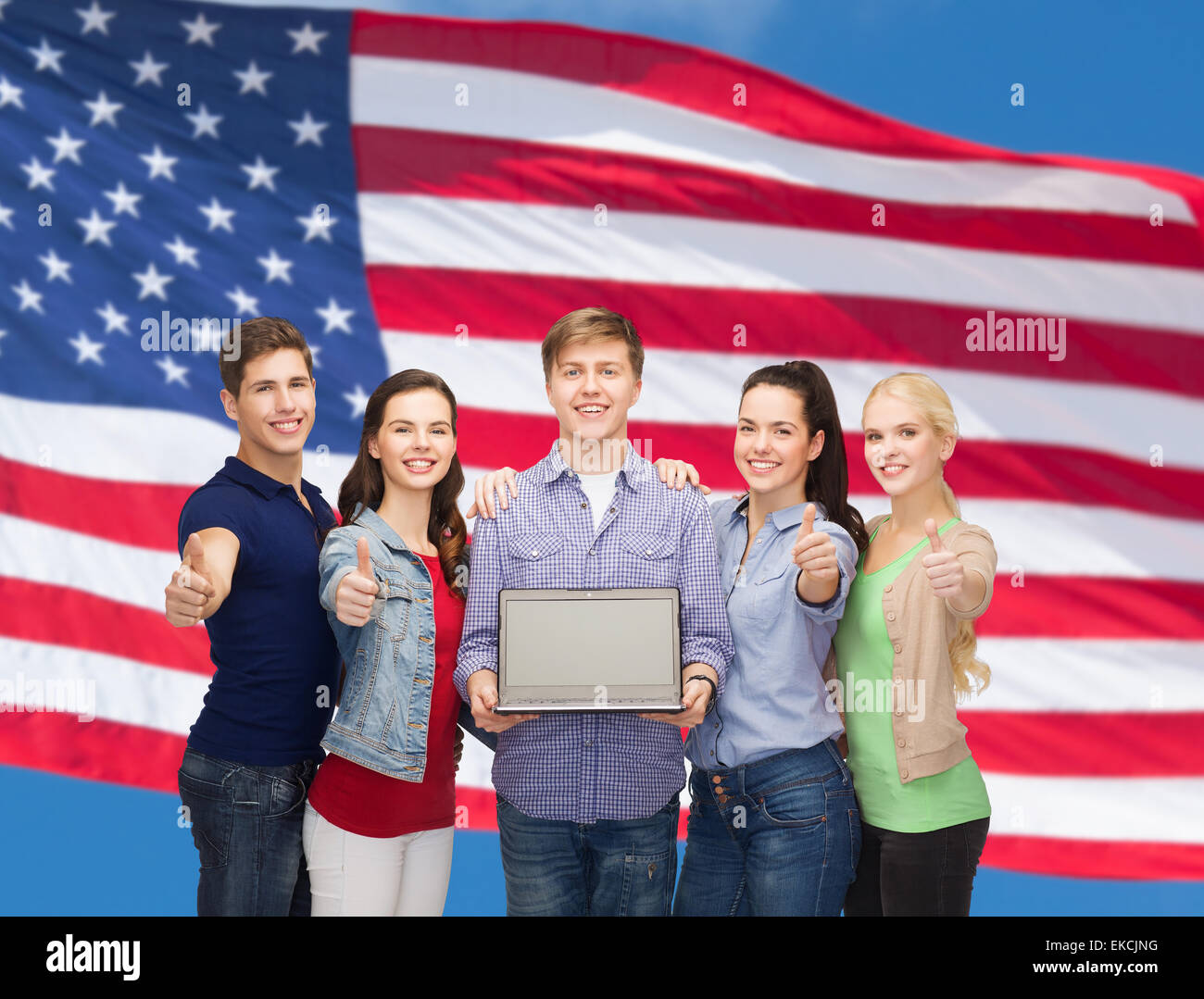 smiling students with laptop computer Stock Photo - Alamy