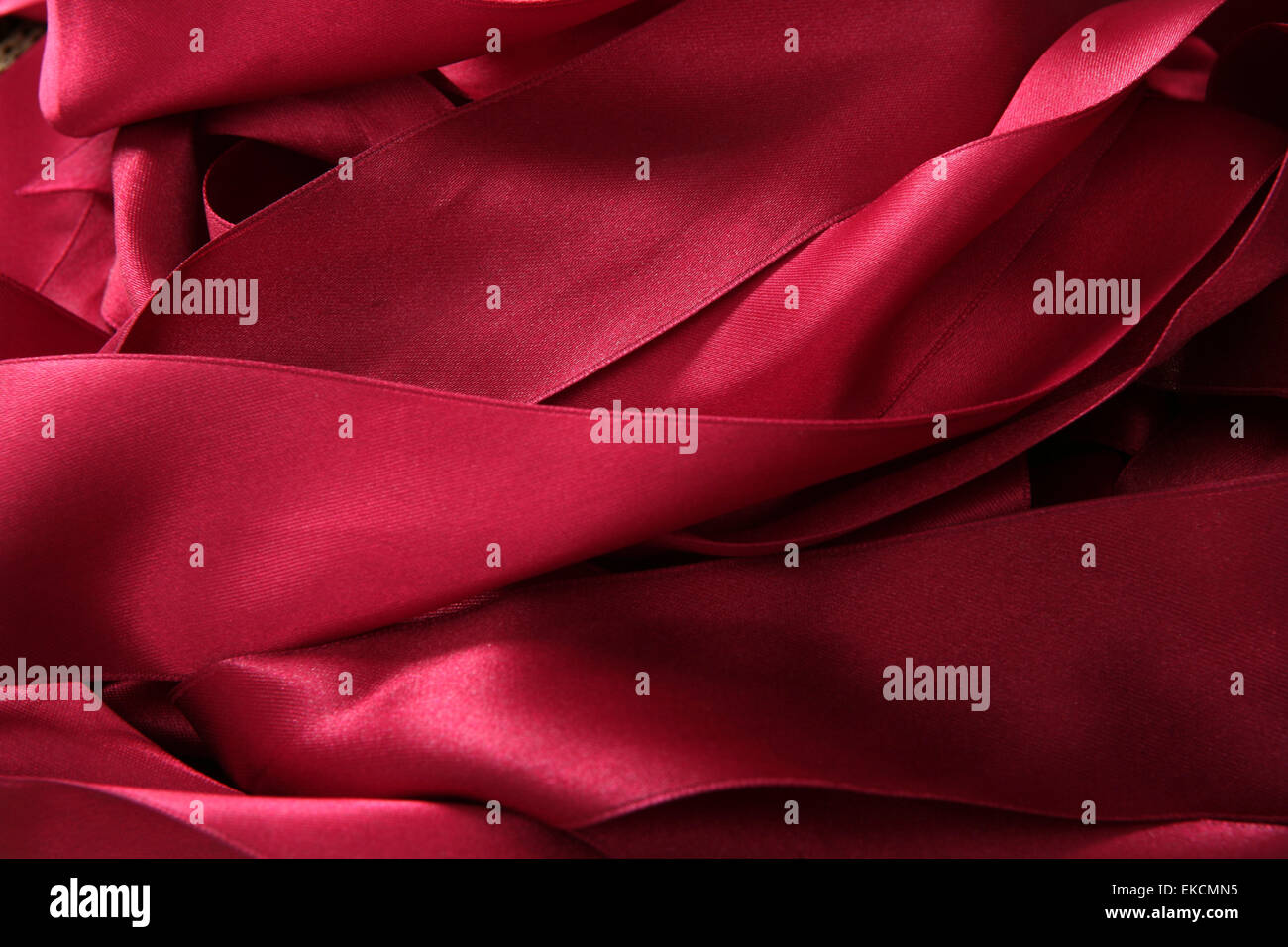 Red satin ribbons in a messy mess texture Stock Photo - Alamy