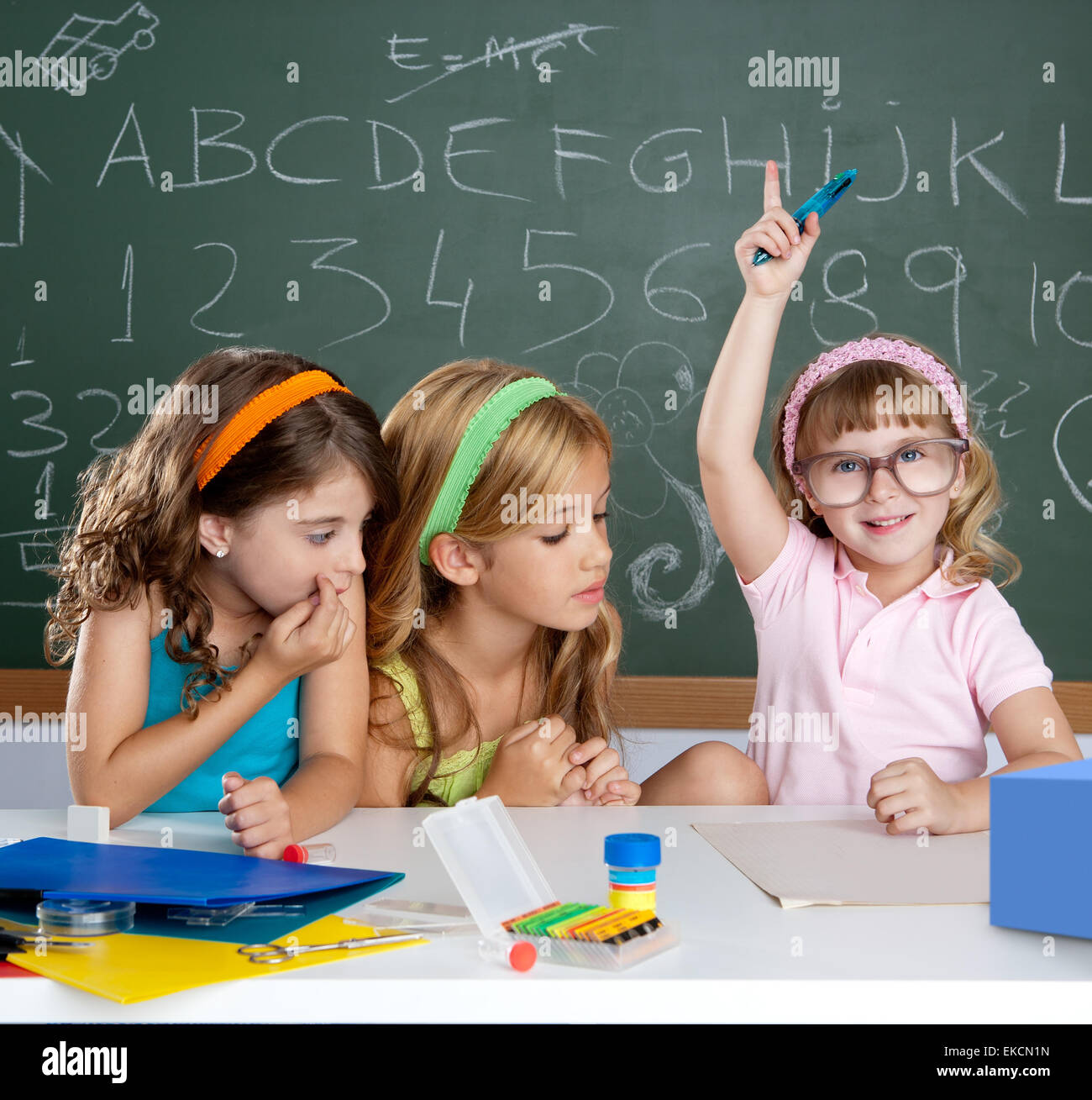 boring student with clever children girl raising hand Stock Photo - Alamy