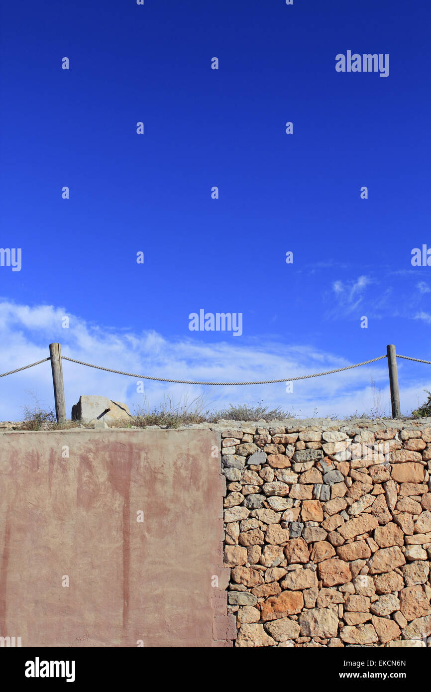traditional rope fence over stone wall grunge Stock Photo - Alamy