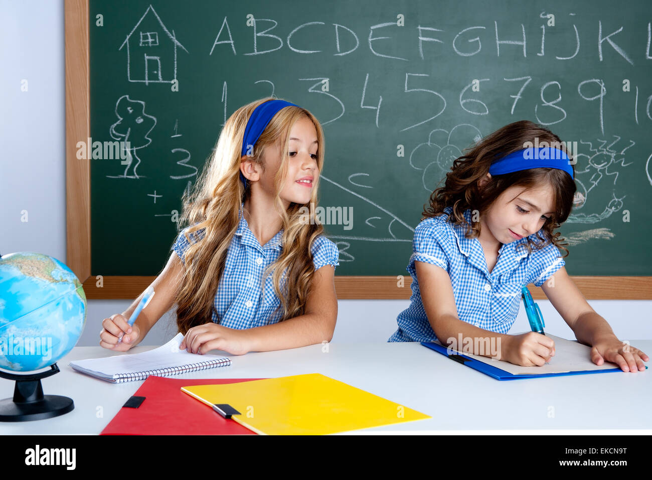 classroom with two kids students cheating on test Stock Photo - Alamy