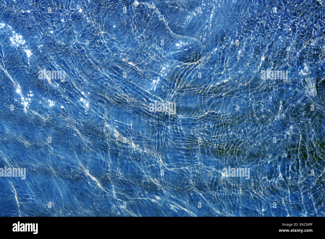 blue shallow water wavy reflection on beach Stock Photo - Alamy