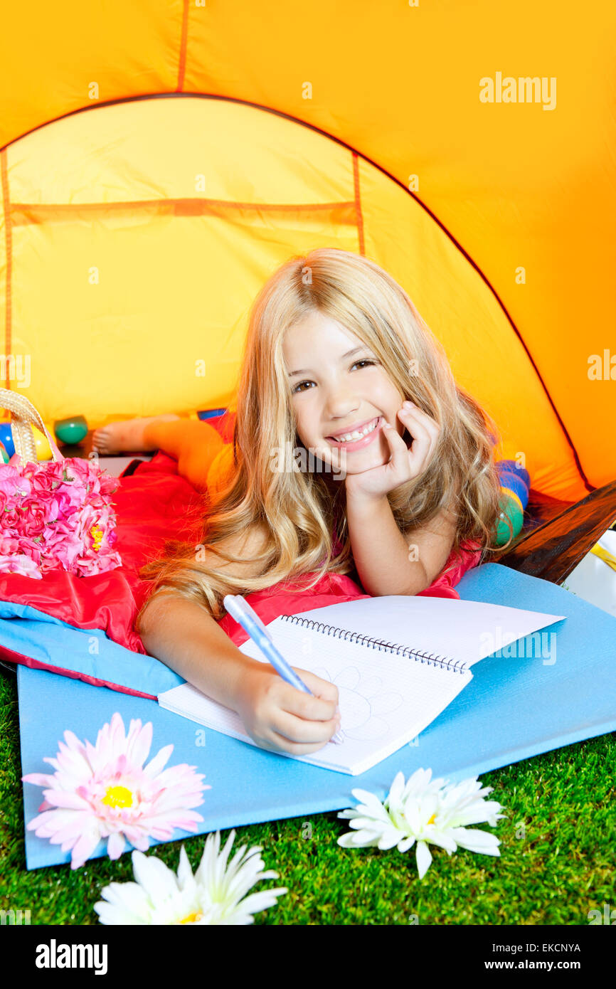 Children girl writing notebook in camping tent with flowers Stock Photo ...