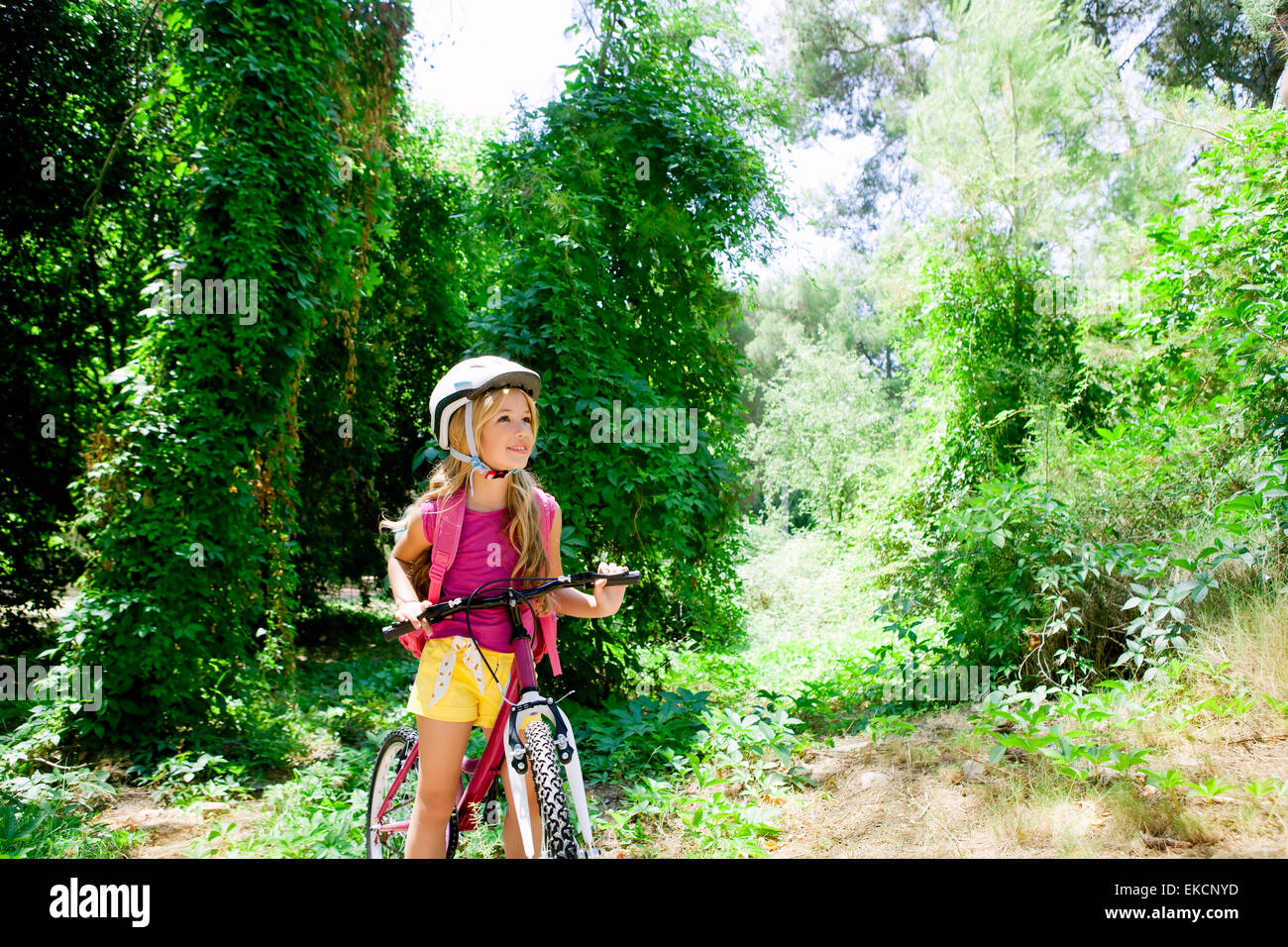 Children girl riding bicycle outdoor in forest smiling Stock Photo - Alamy
