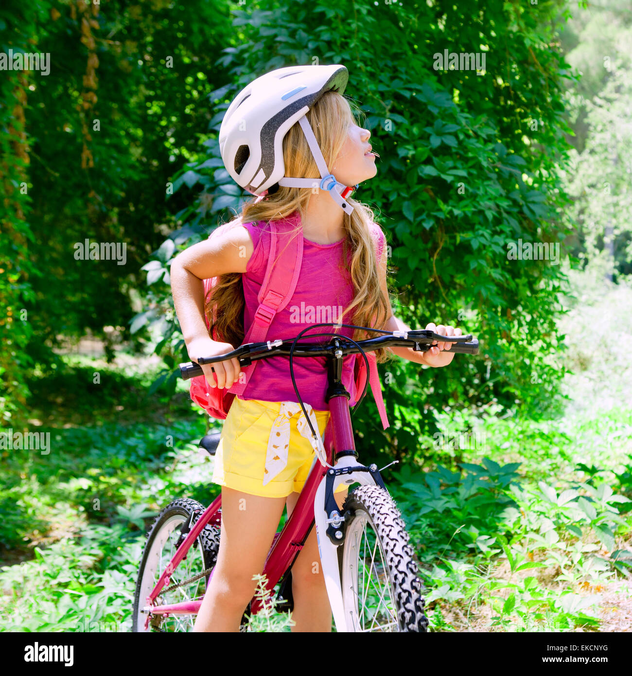 Children girl riding bicycle outdoor in forest smiling Stock Photo - Alamy