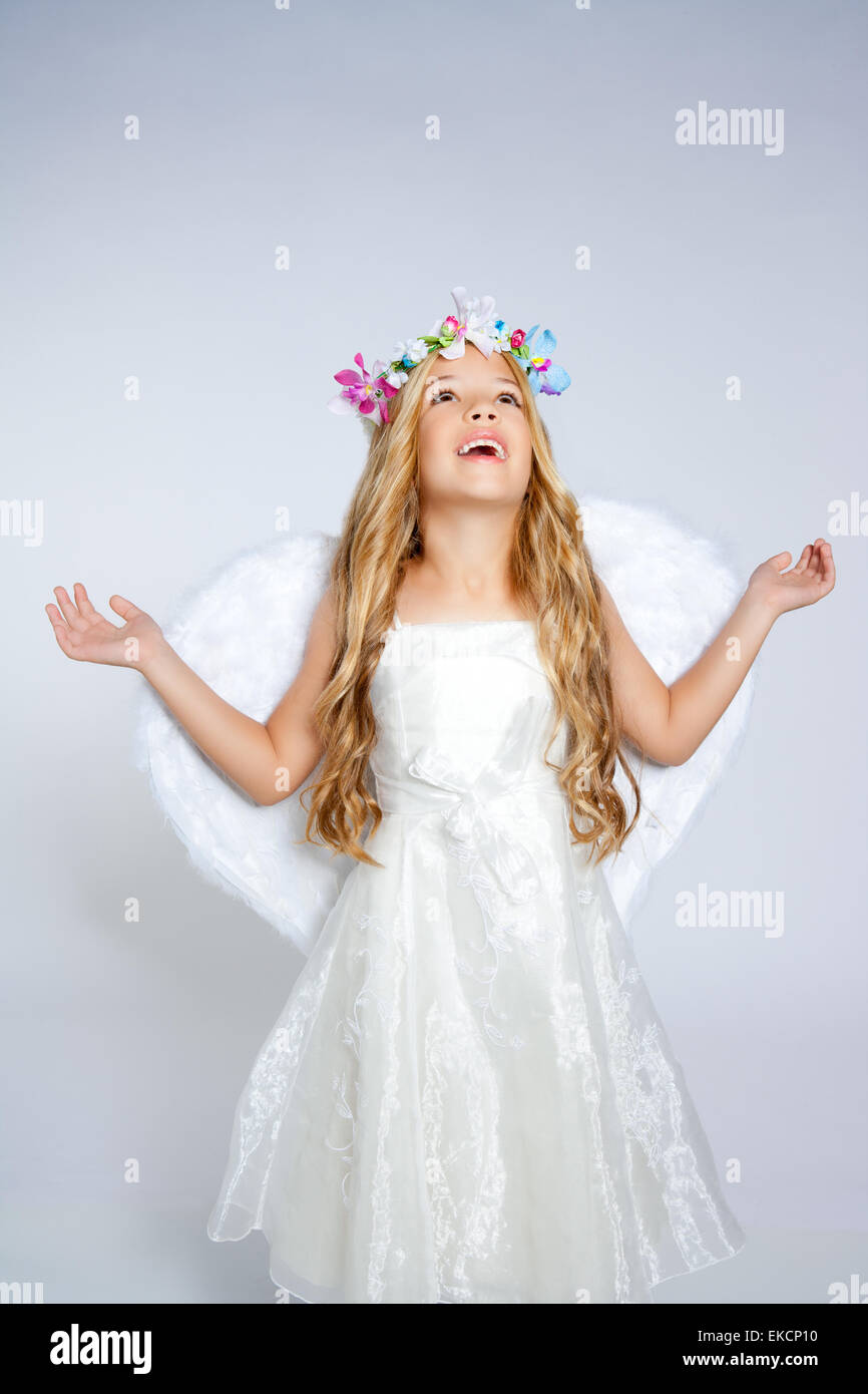 Children angel girl looking up sky with open hands Stock Photo - Alamy