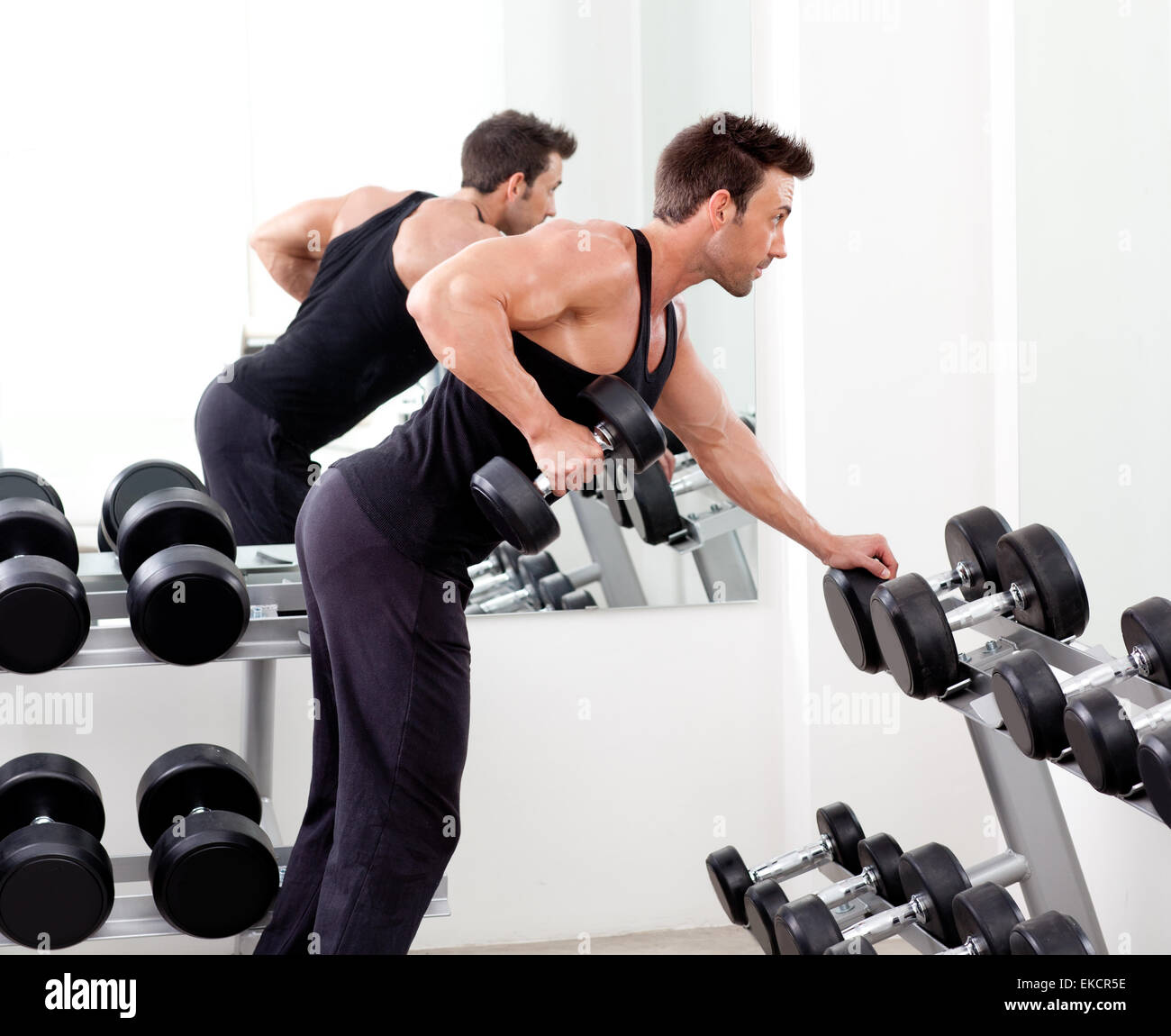 Man with weight training equipment on sport gym Stock Photo - Alamy