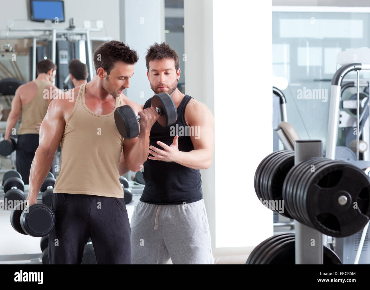 gym personal trainer man with weight training Stock Photo - Alamy