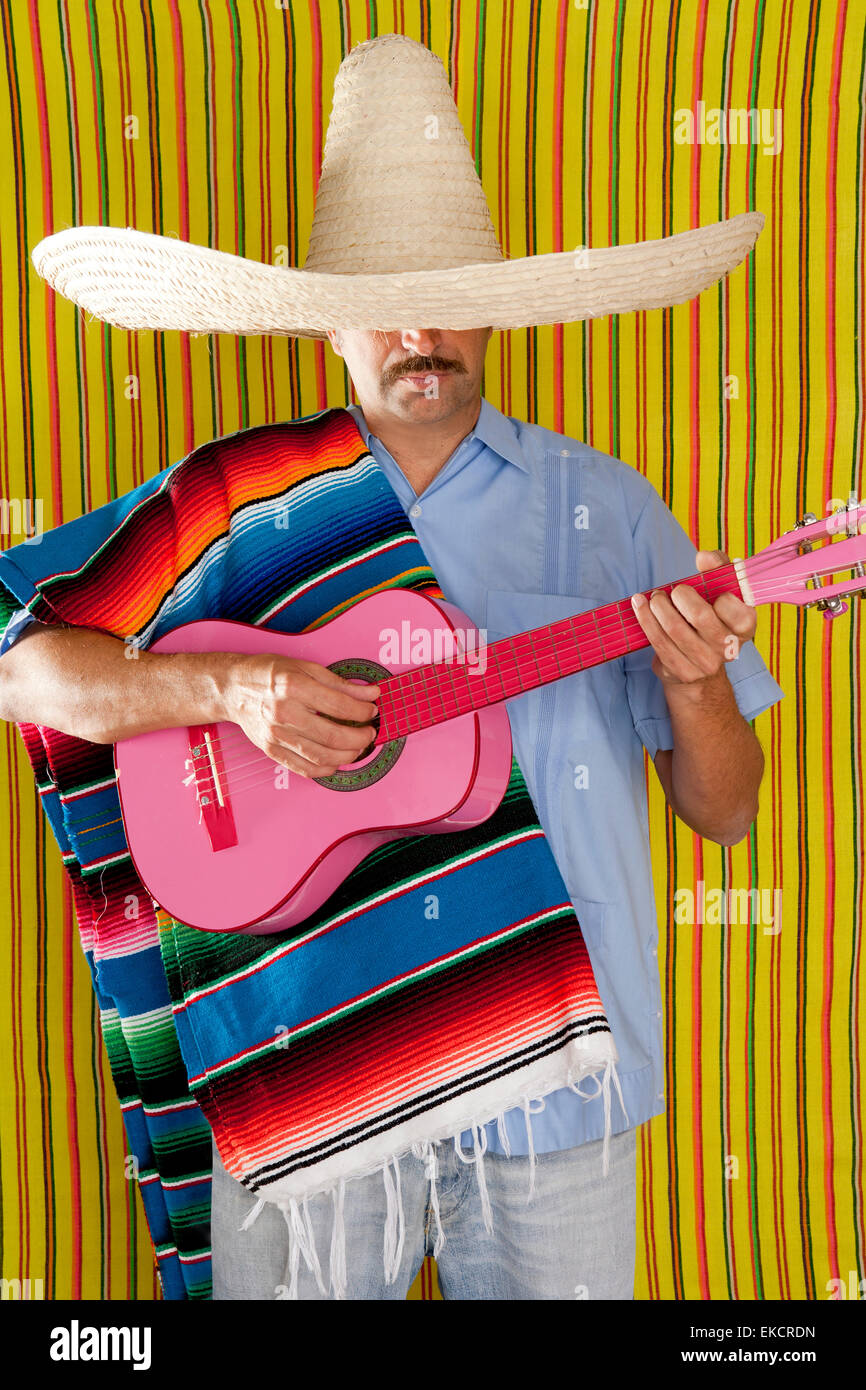 Mexican man serape poncho sombrero playing guitar Stock Photo - Alamy
