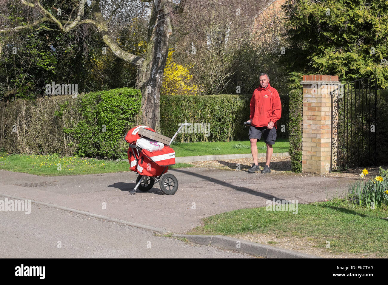 Village postman with mail trolley Stock Photo - Alamy