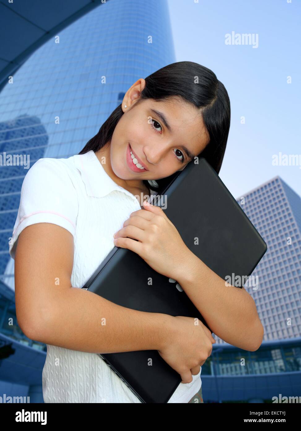 latin teenager brunette student hug laptop Stock Photo - Alamy